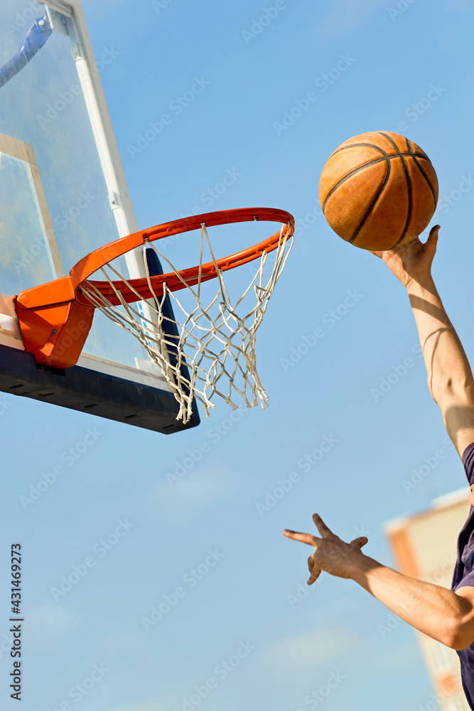 Close-up of a guy throwing a basketball into the basket Stock Photo ...