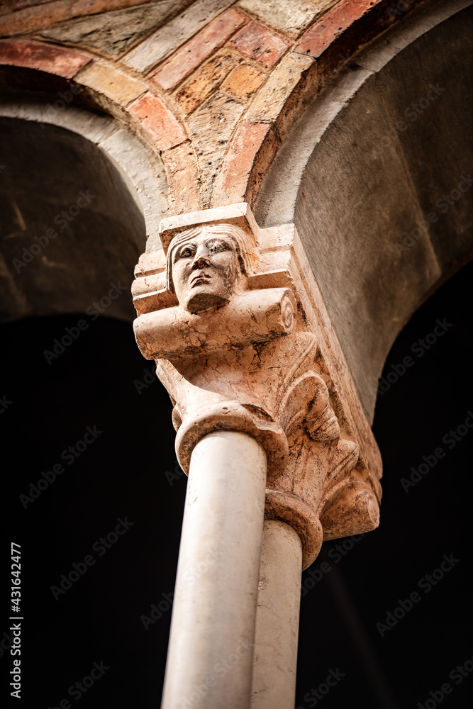 Ancient columns with capitals in the shape of a human head, cloister of ...