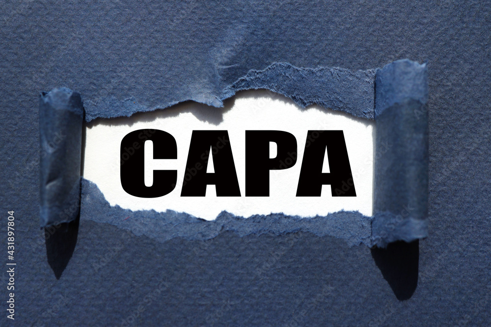 CAPA Corrective and Preventive action plans. text inside torn blue ...