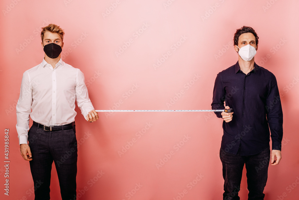 Business people measuring social distance with measuring tape while ...