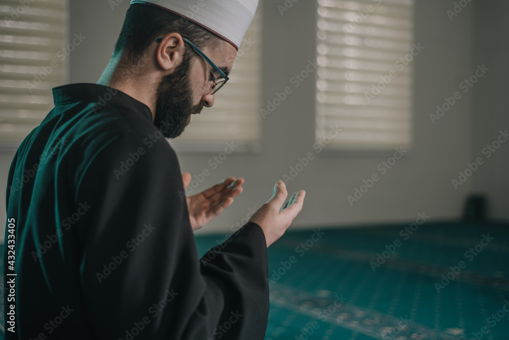 Muslim man praying in mosque Stock Photo | Adobe Stock