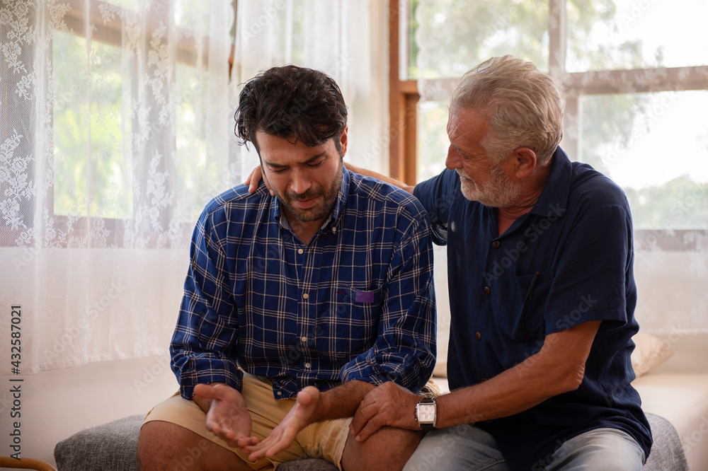 Caucasian senior father comforting and hugging depressed adult son in ...