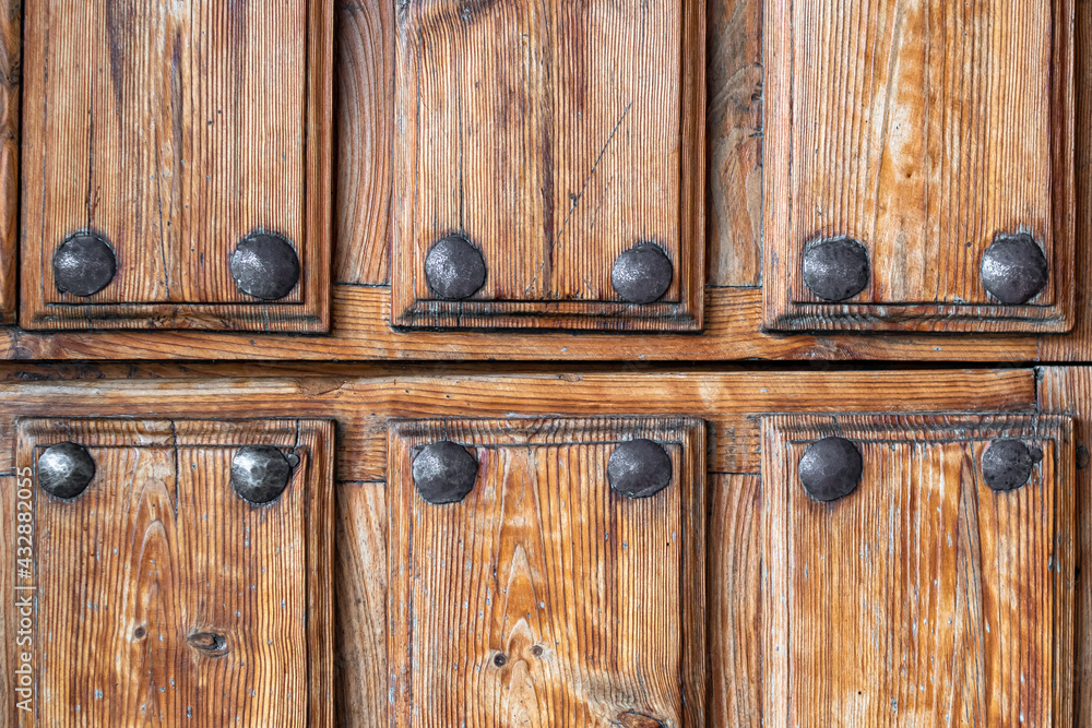 Antique wooden door with nails and knots. Rustic and retro old door ...
