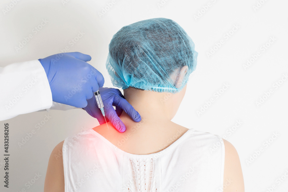 The doctor makes an injection medical blockade into the paravertebral ...