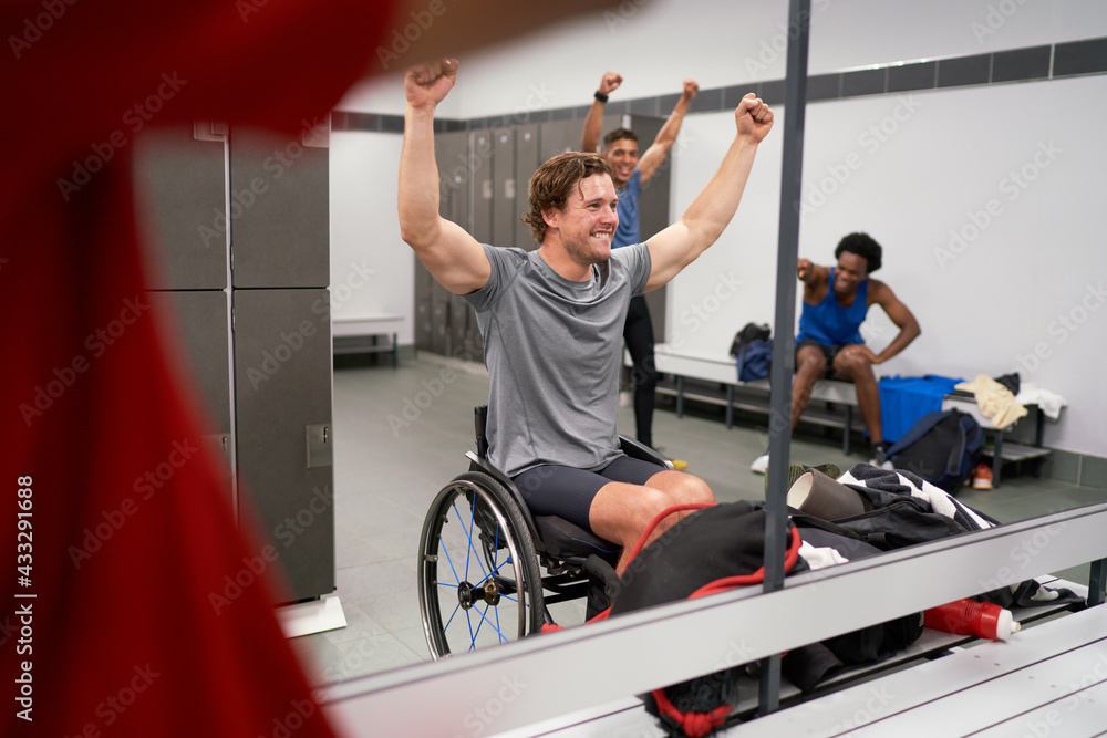 Confident happy wheelchair athlete cheering in locker room mirror Stock ...