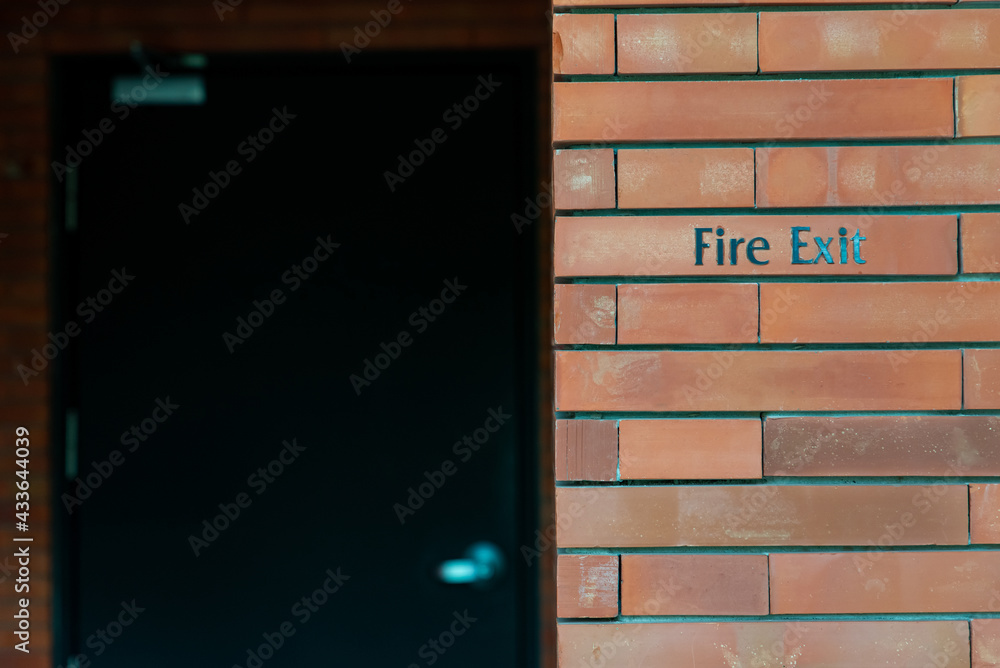 Building emergency door with exit sign. Fire exit doorway made by brick ...