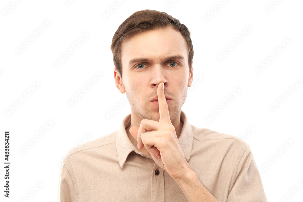 Portrait of brunette man in casual showing finger shhh isolated on ...