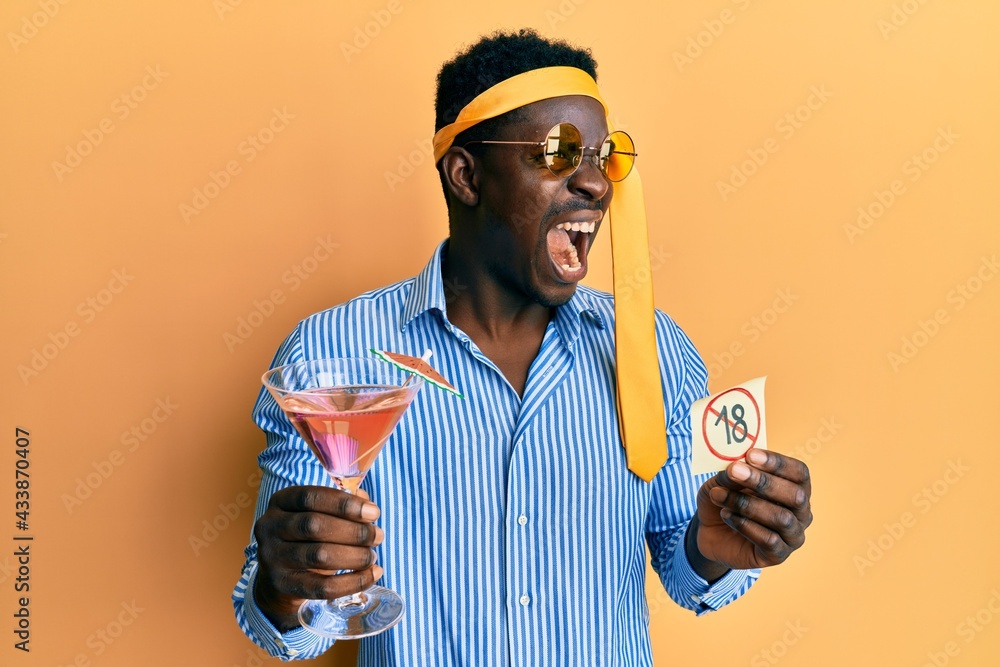 Handsome black man drunk wearing tie over head drinking cocktail ...