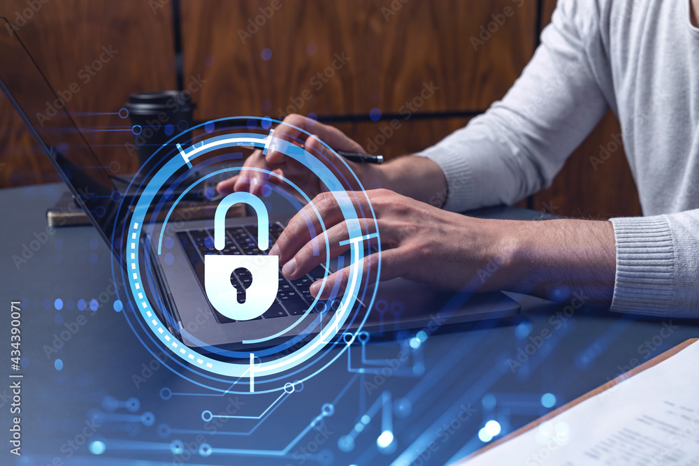 A programmer is typing a code on a keyboard to protect a cyber security from hacker attacks and ...