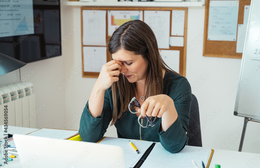 Young tired female online professor having headache. Stressed woman ...