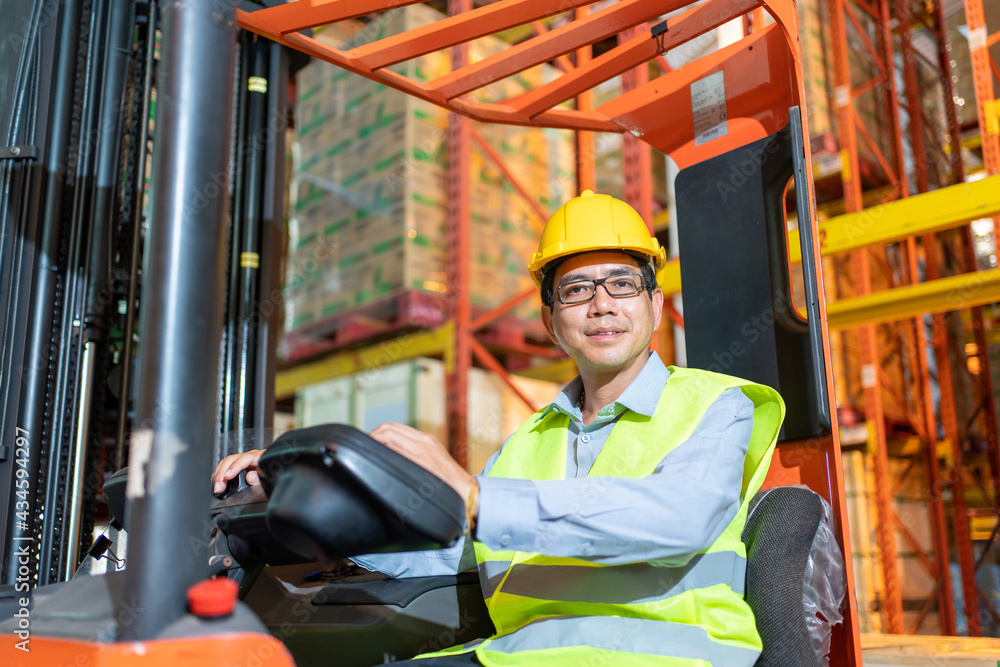 Forklift driver asian man in safety jumpsuit uniform with yellow ...
