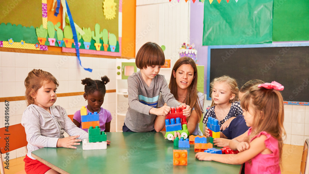 Group of multicultural children playing with building blocks Stock ...