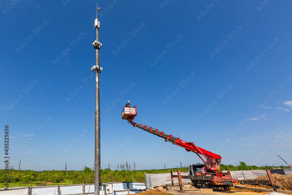Engineer starts working on the telecommunication tower from aerial work ...
