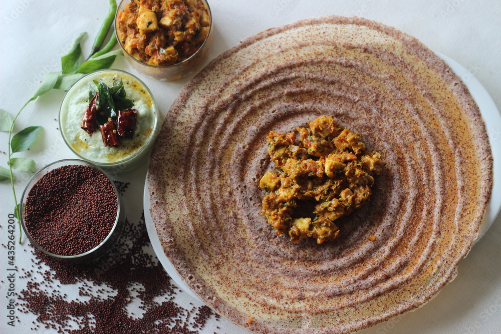 Crispy pancake made of fermented whole grain finger millet batter ...