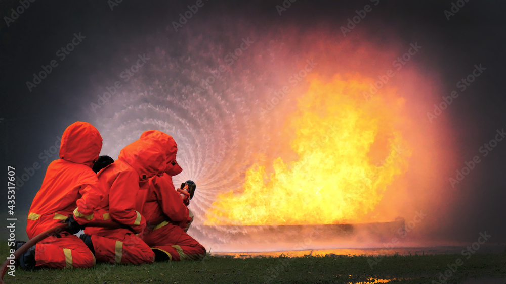 Firefighter fighting with flame using fire hose chemical water foam ...