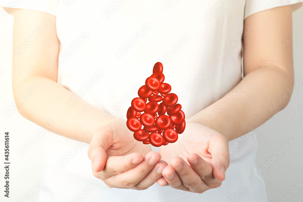 Blood donation. Human hands holding blood drop shape of red blood cells ...