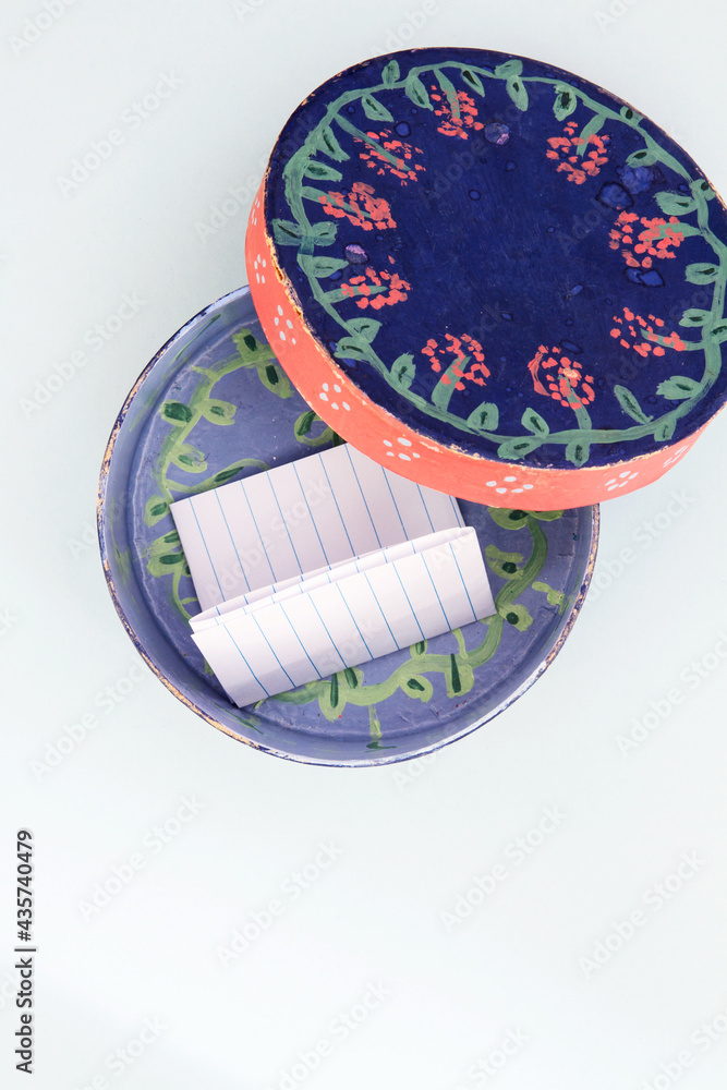 Folded letter placed in a round box for safe keeping; secret note ...