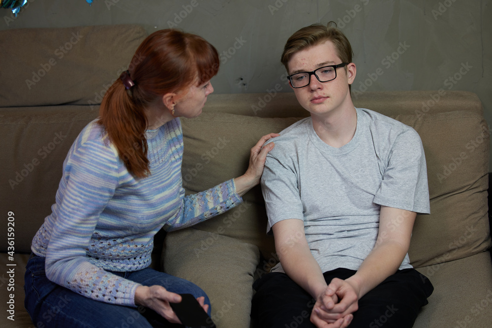 Stock-Foto „Mother and teenage son are talking at home with family ...