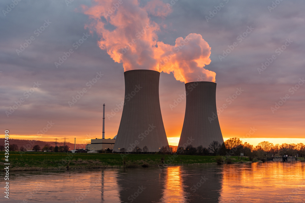 Foto Nuclear power plant against sky by the river at sunset do Stock ...