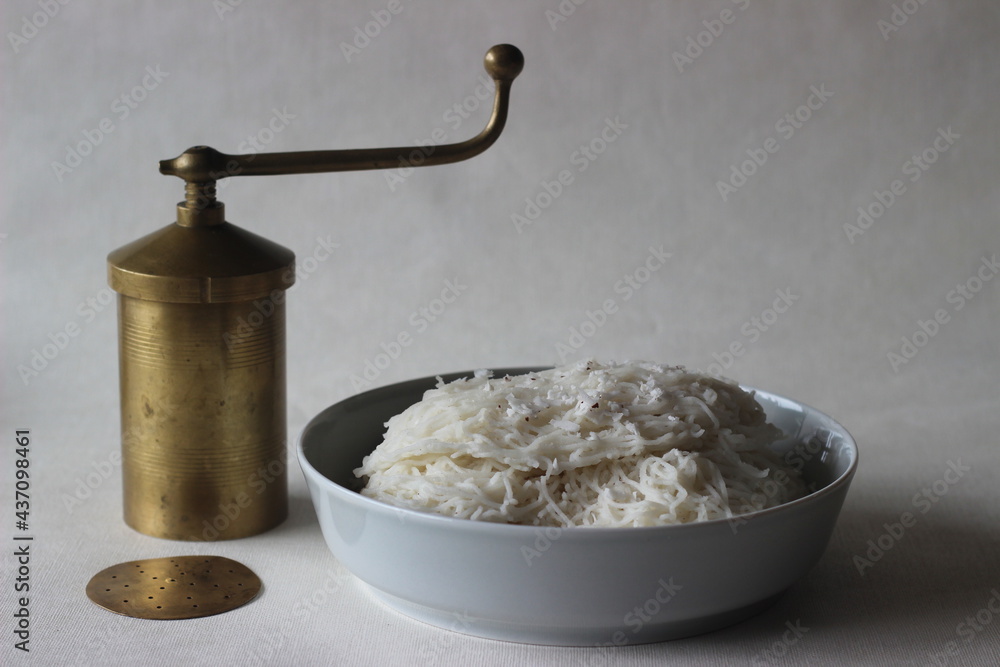 String hoppers, a steamed rice noodle dish shot along with the press to ...
