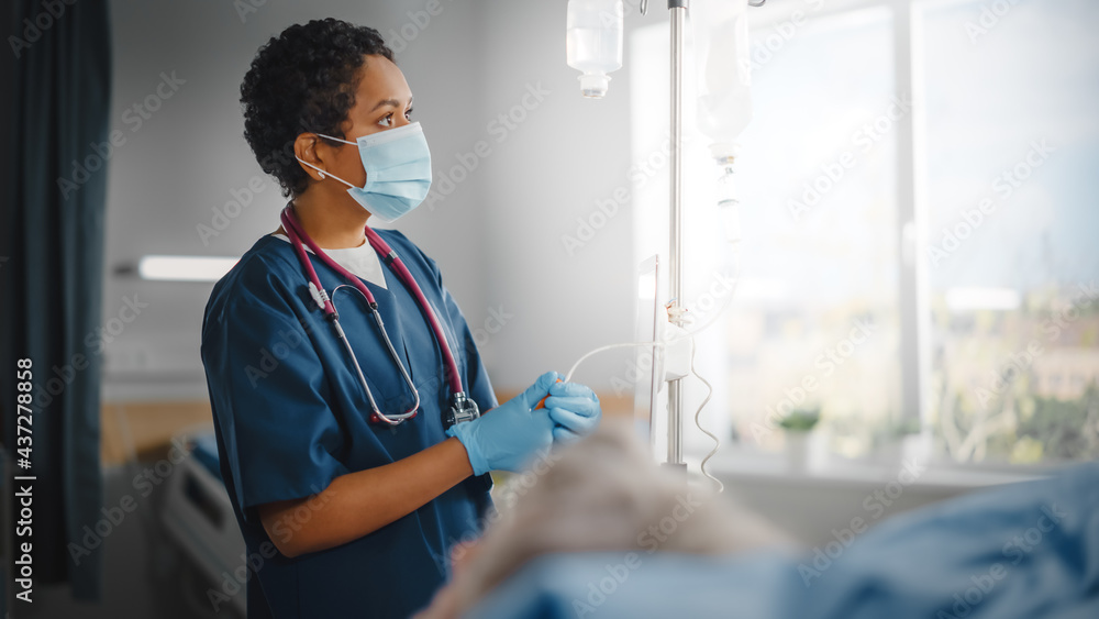Hospital Ward: Professional Black Head Nurse Wearing Face Mask Does Checkup of Patient's Vitals ...