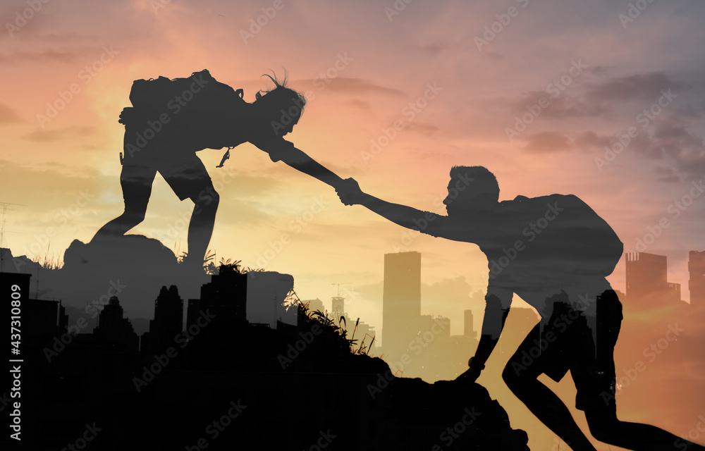 Giving a helping hand to someone in need. Hikers climbing up a mountain ...