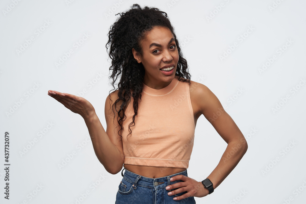 indoor shot of young african american looks directly into camera with a ...