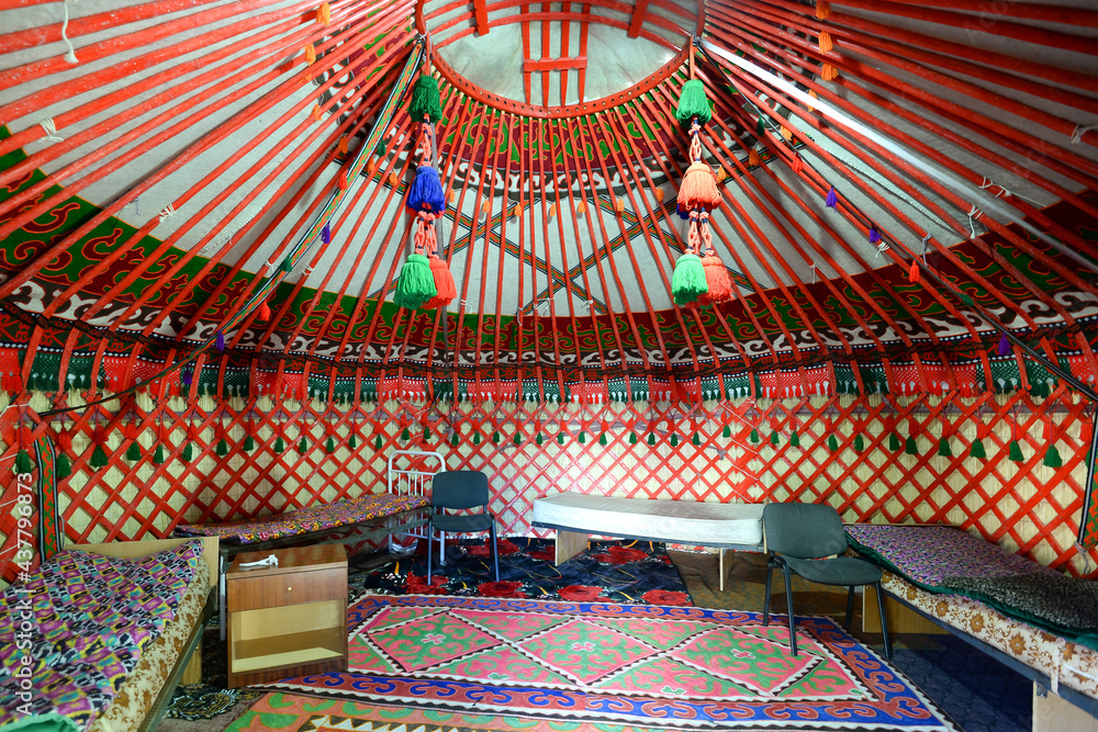 Inside view of a yurt in Bokonbayevo, Kyrgyzstan. Circular tent used as ...