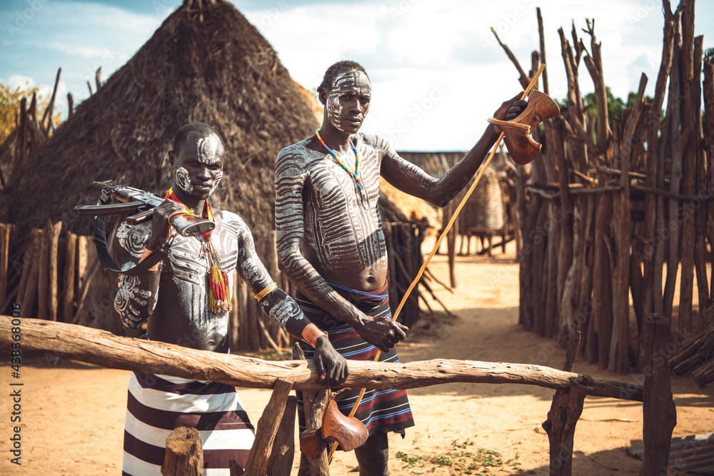 Tribal men defending village borders Stock Photo | Adobe Stock