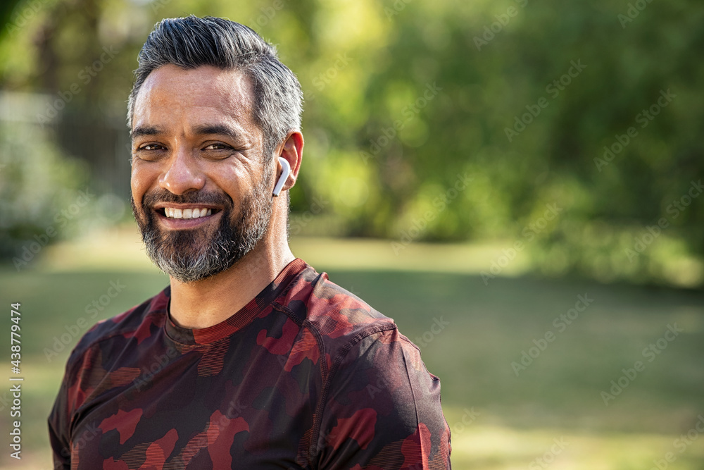 Mid adult indian man smiling after running Stock Photo | Adobe Stock