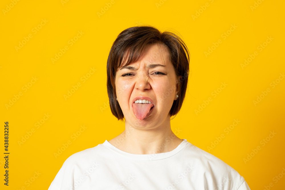 Dissatisfied female frowns face, has disgusting expression, shows ...