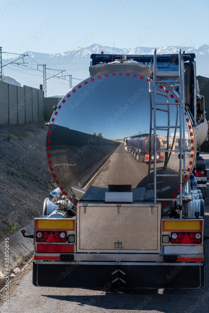 Rear of a tank truck with mirror reflection and where another tank ...