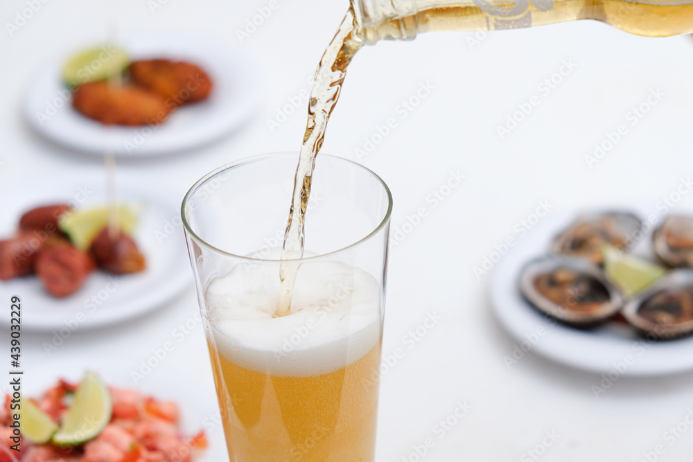 Cerveza con bocas de conchas, ceviches y chorizo Stock Photo | Adobe Stock