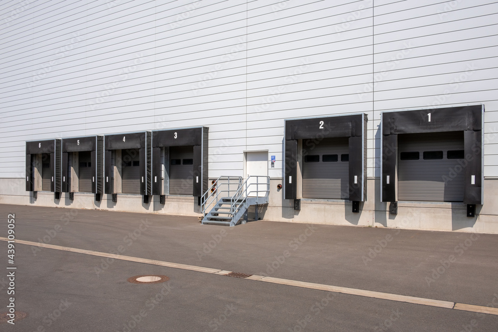 Trucks at loading ramps of a warehouse. Image for delivery, delivery ...