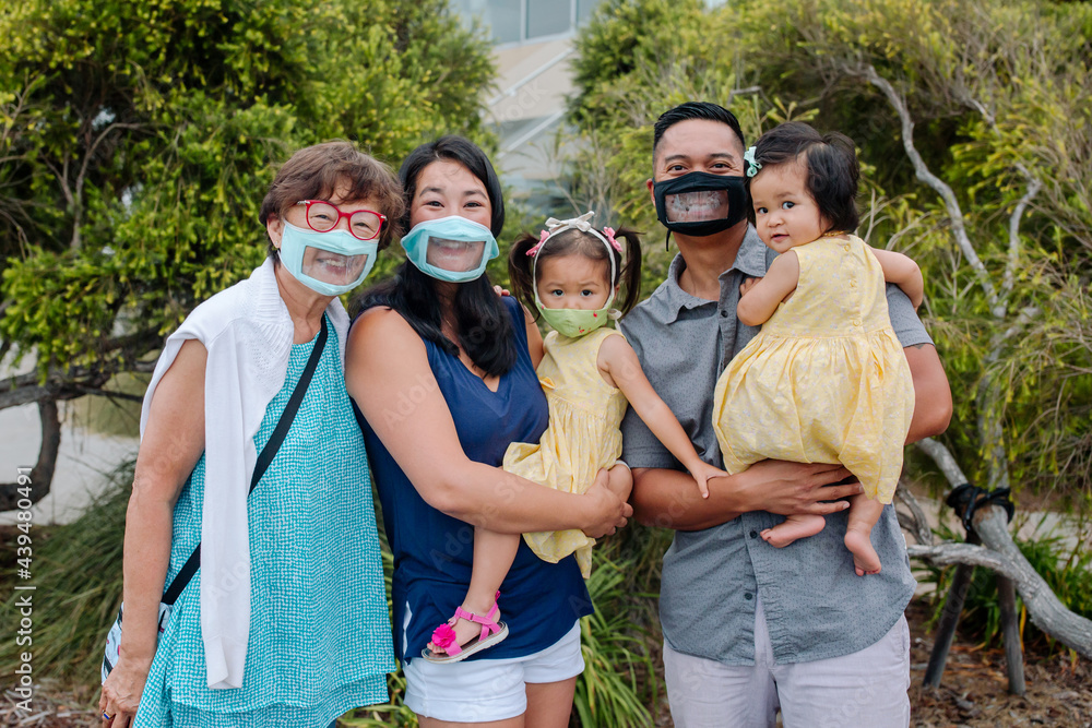Beautiful multi-generational family outdoors wearing masks Stock Photo ...