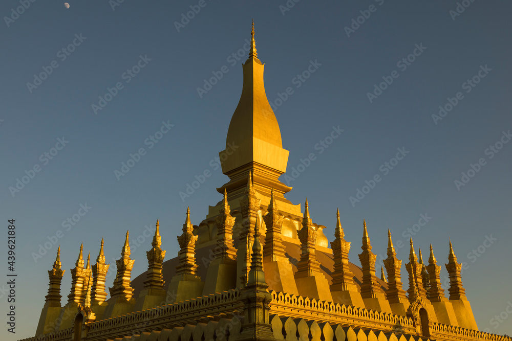 Pha That Luang at sunset, in Vientiane, Laos, is a large gold-covered ...