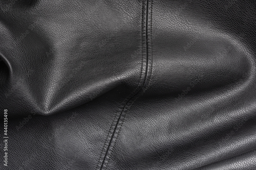 Closeup of black heavy leather material with a seam in the middle, deep ...