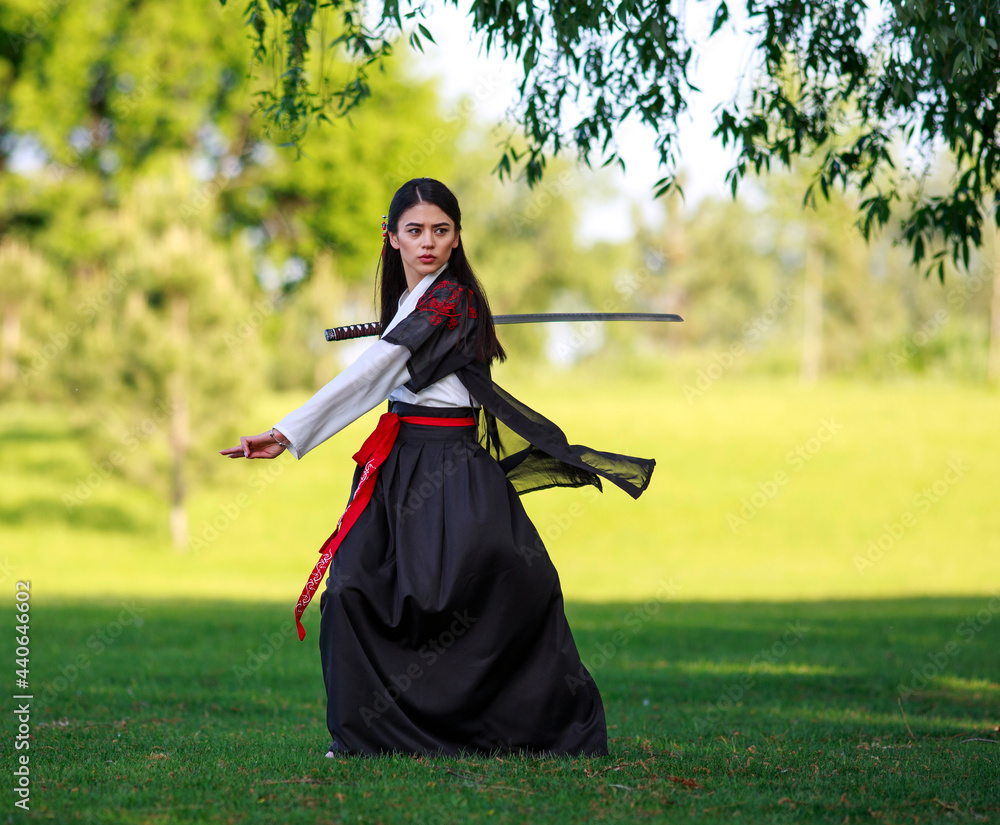 Young asian woman in traditional kimono trains fighting techniques with ...