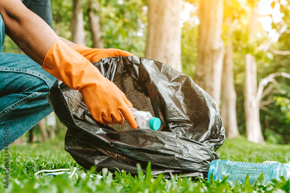 Volunteer man collecting trash.Garbage bottles picked up. Plastic and ...