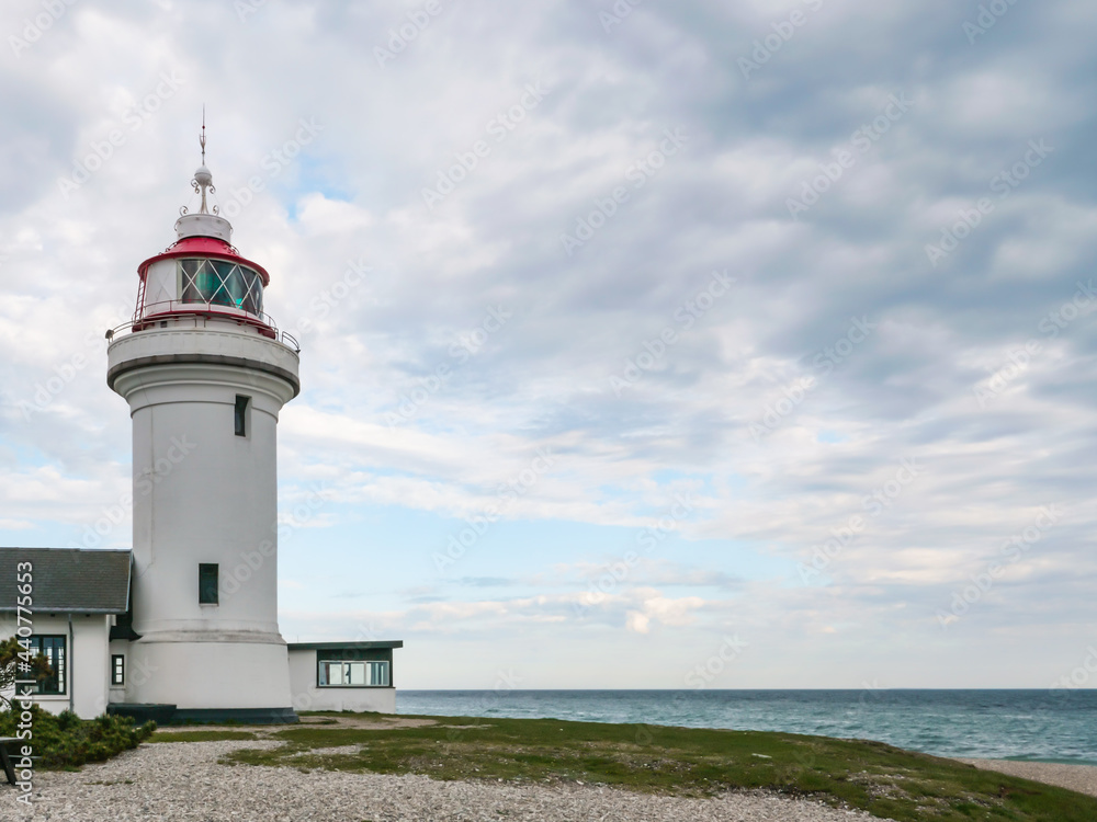 Lighthouse tower on a beach. The Lighthouse - Sletterhage fyr was built ...