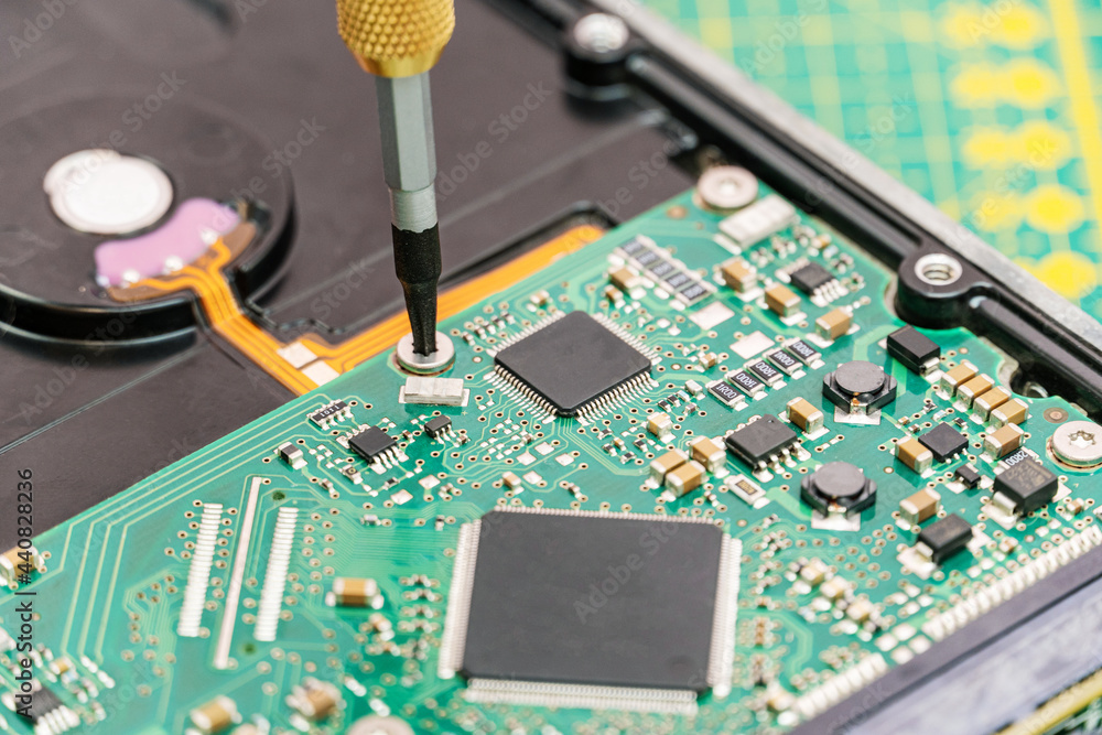 hard disk drive disassembling process with screwdriver in information ...