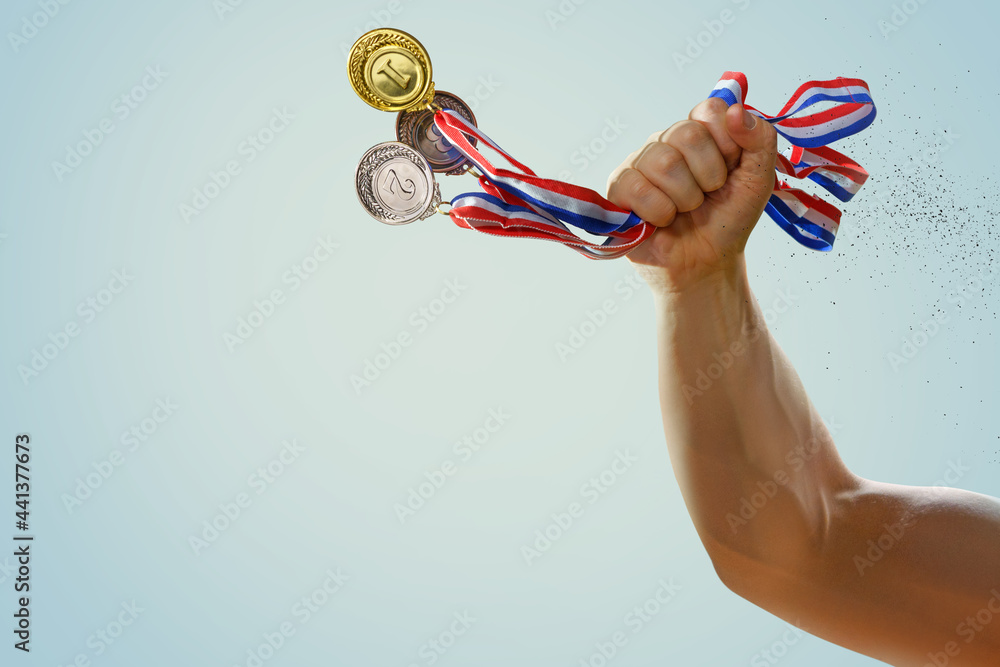 different medals in hand - Victory Concept Stock Photo | Adobe Stock