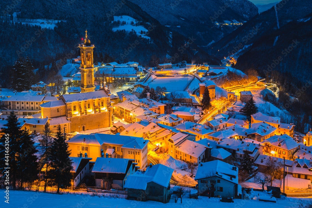 village with church and bell tower in winter season at blue hour ...