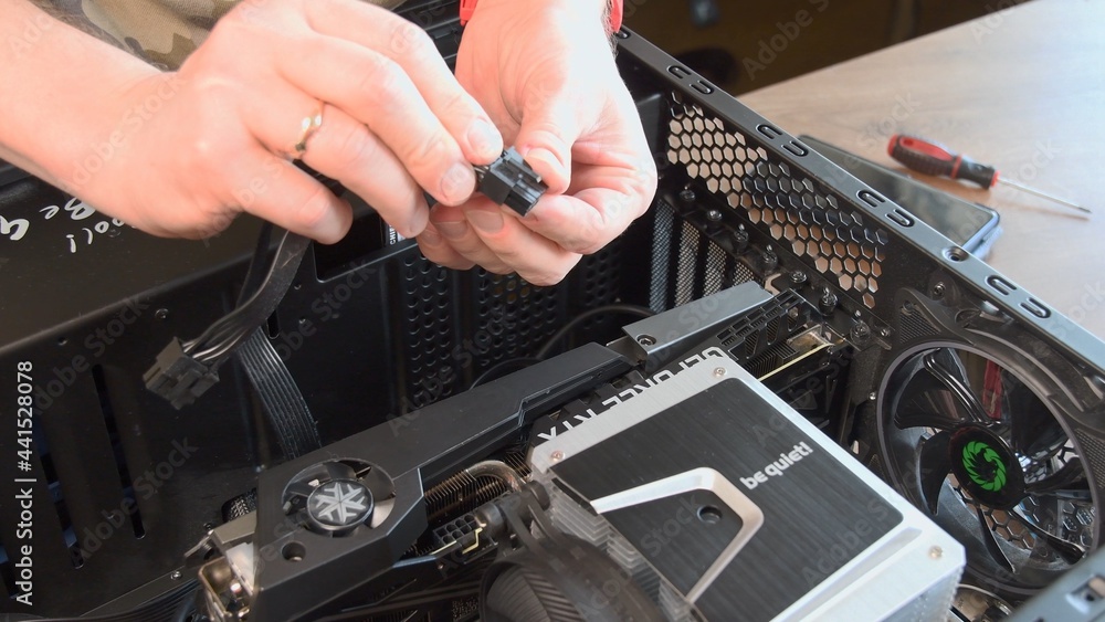 Hands assemble CPU cooler and NVidia GeForce RTX 3080 graphics card in ...
