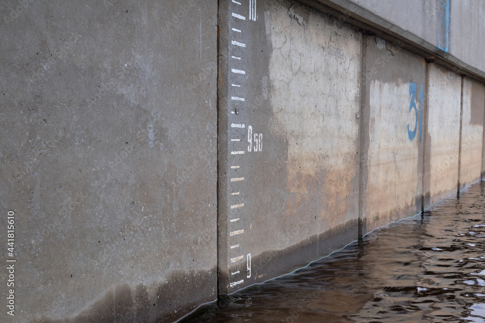 Water level measurement gauge during flood. depth marker on the wall ...