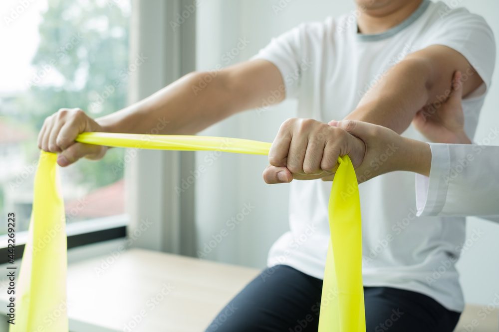 Female physiotherapists are helping male patients with arm injuries ...