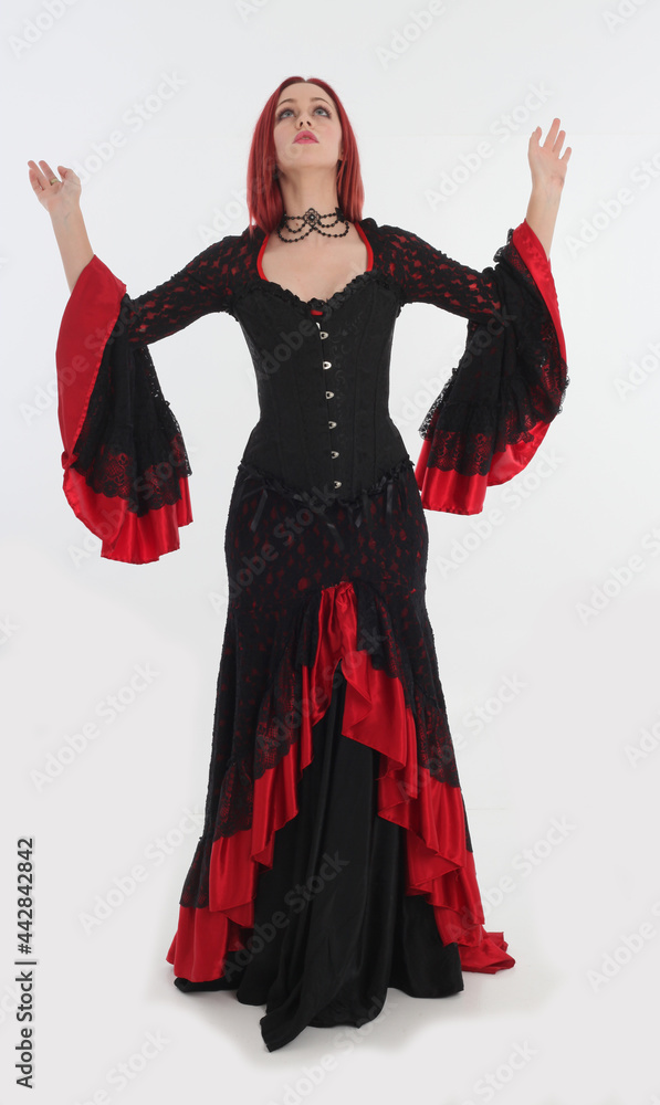 full length portrait of red haired woman wearing long black gothic ...