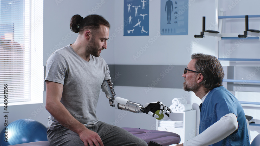Doctor teaching patient to use prosthetic arm Stock Photo | Adobe Stock