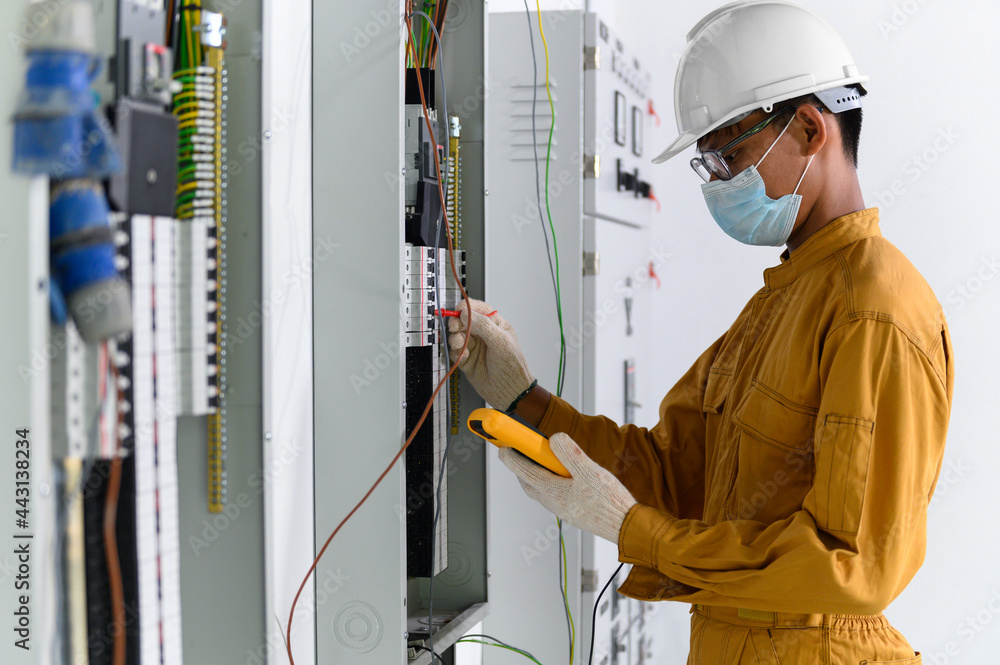 Electrician engineer using digital multimeter test current electric in ...