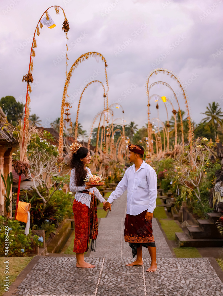 Balinese ceremony. Multicultural couple going to Hindu religious ...